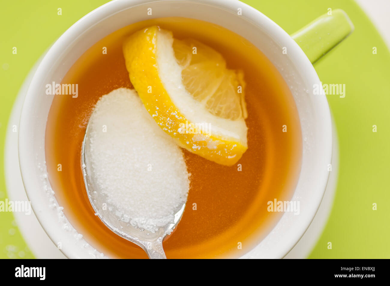 Spoon with sugar substitute, sorbitol dissolved in a cup of tea with ...