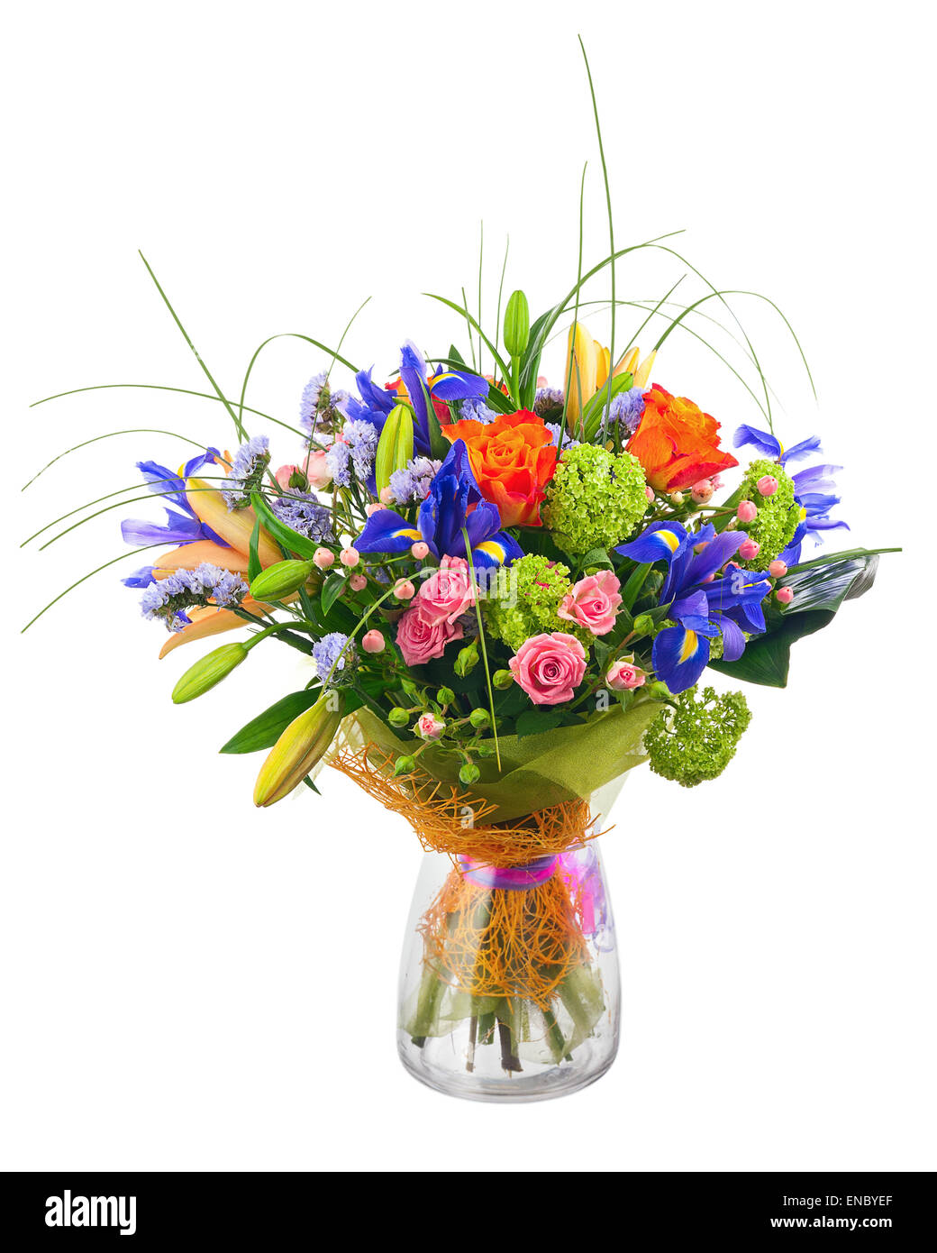 Flower bouquet from roses, iris and statice flowers in glass vase ...
