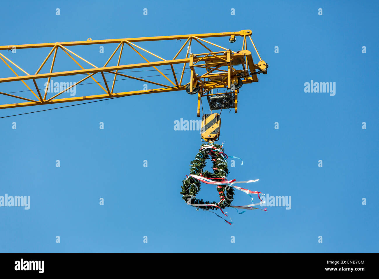 Construction crane with a topping-out wreath, topping-out ceremony ...
