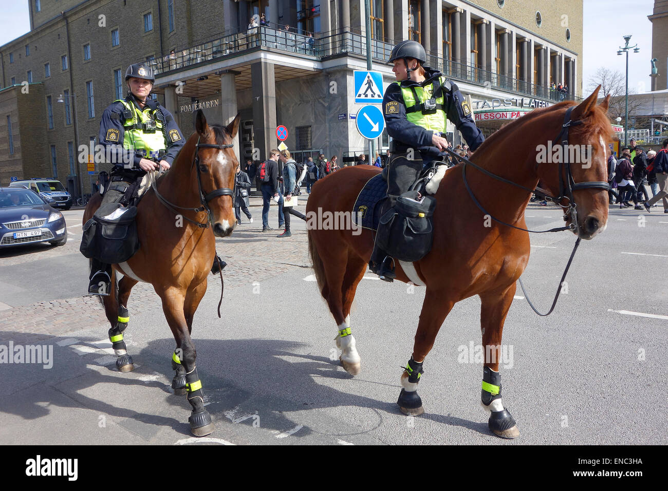 Two mounted female Swedish police officers patrolling on the street of ...