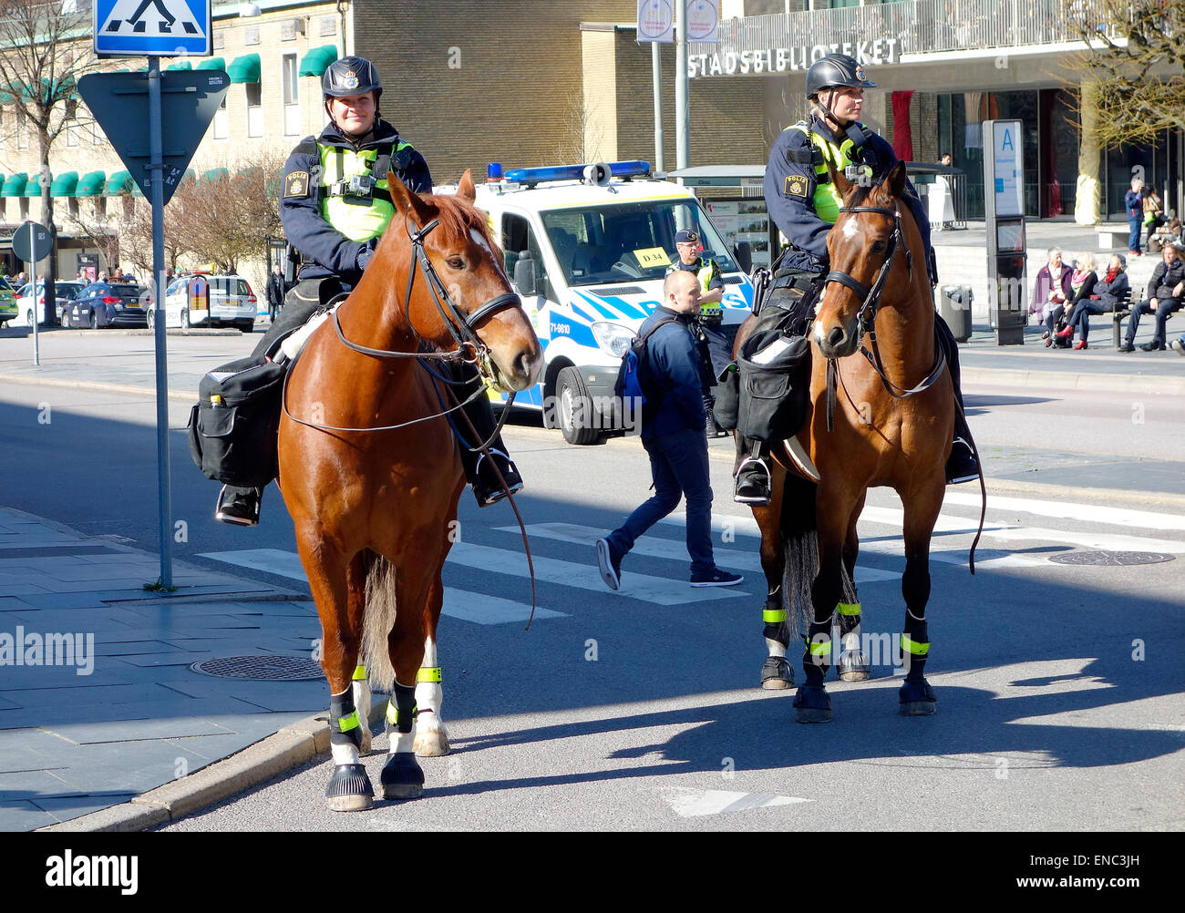 Two mounted female Swedish police officers patrolling on the street of ...