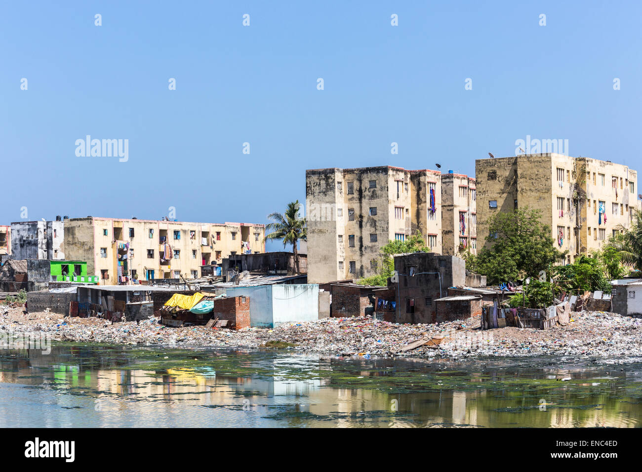 Third world poverty lifestyle: Slums and apartment blocks on the banks ...