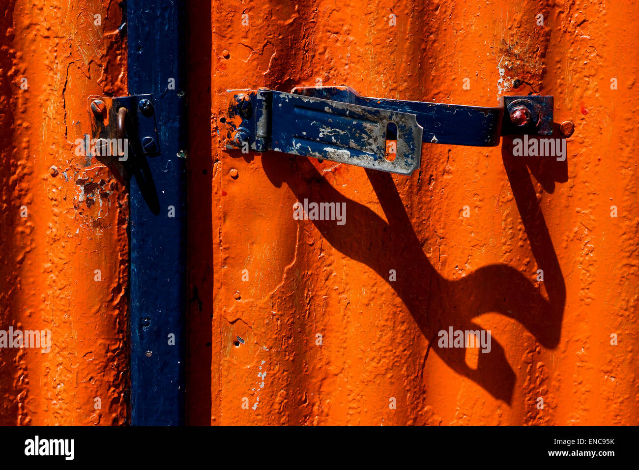a blue safety lock in a red metal wall Stock Photo - Alamy