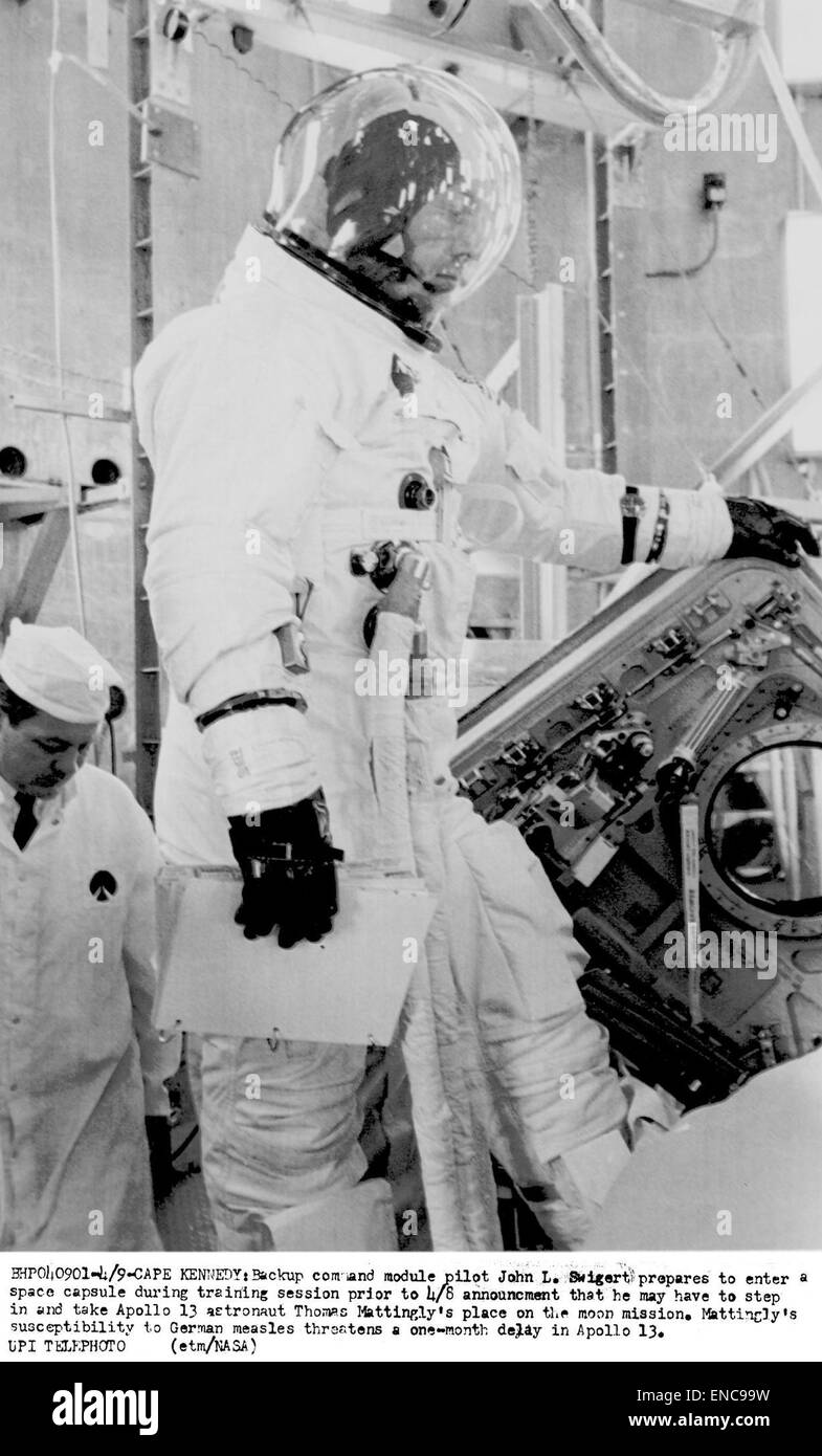 A photograph of astronaut Jack Swigert entering the command module ...