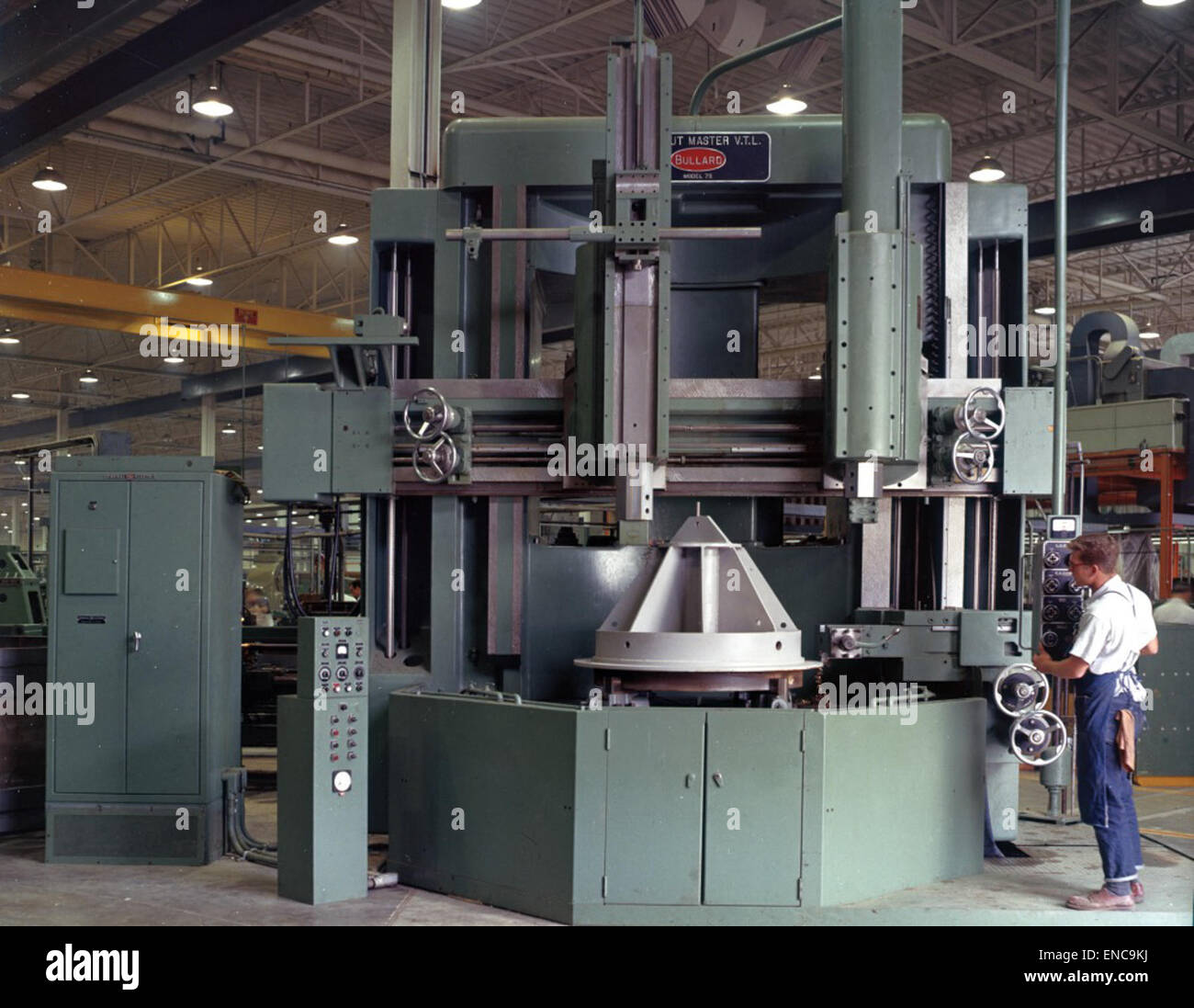 A photograph of workers operating a Bullard vertical lathe in 1959 ...