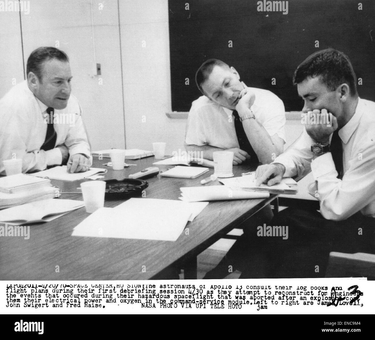 A photograph of the first post-flight debriefing, capturing the moment ...