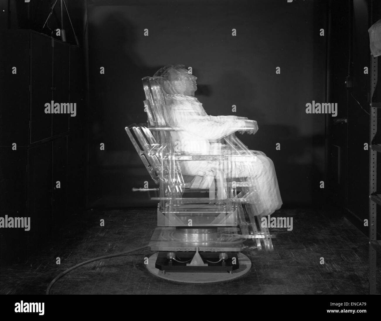 This image shows a man in a motion device, likely an early flight or ...