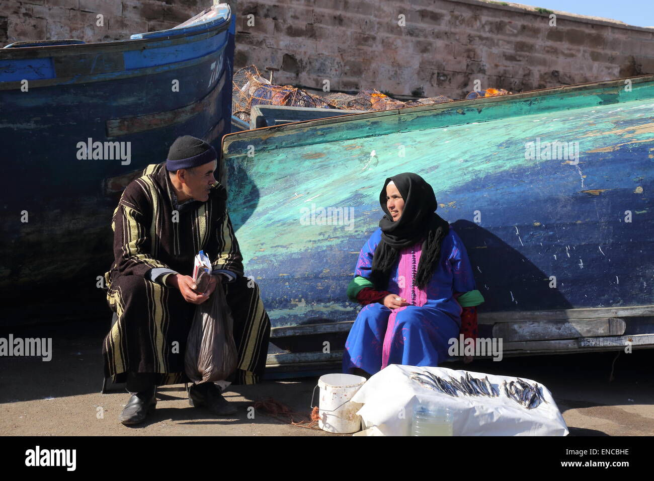 A Berber man in the traditional dress of a djellaba in conversation ...
