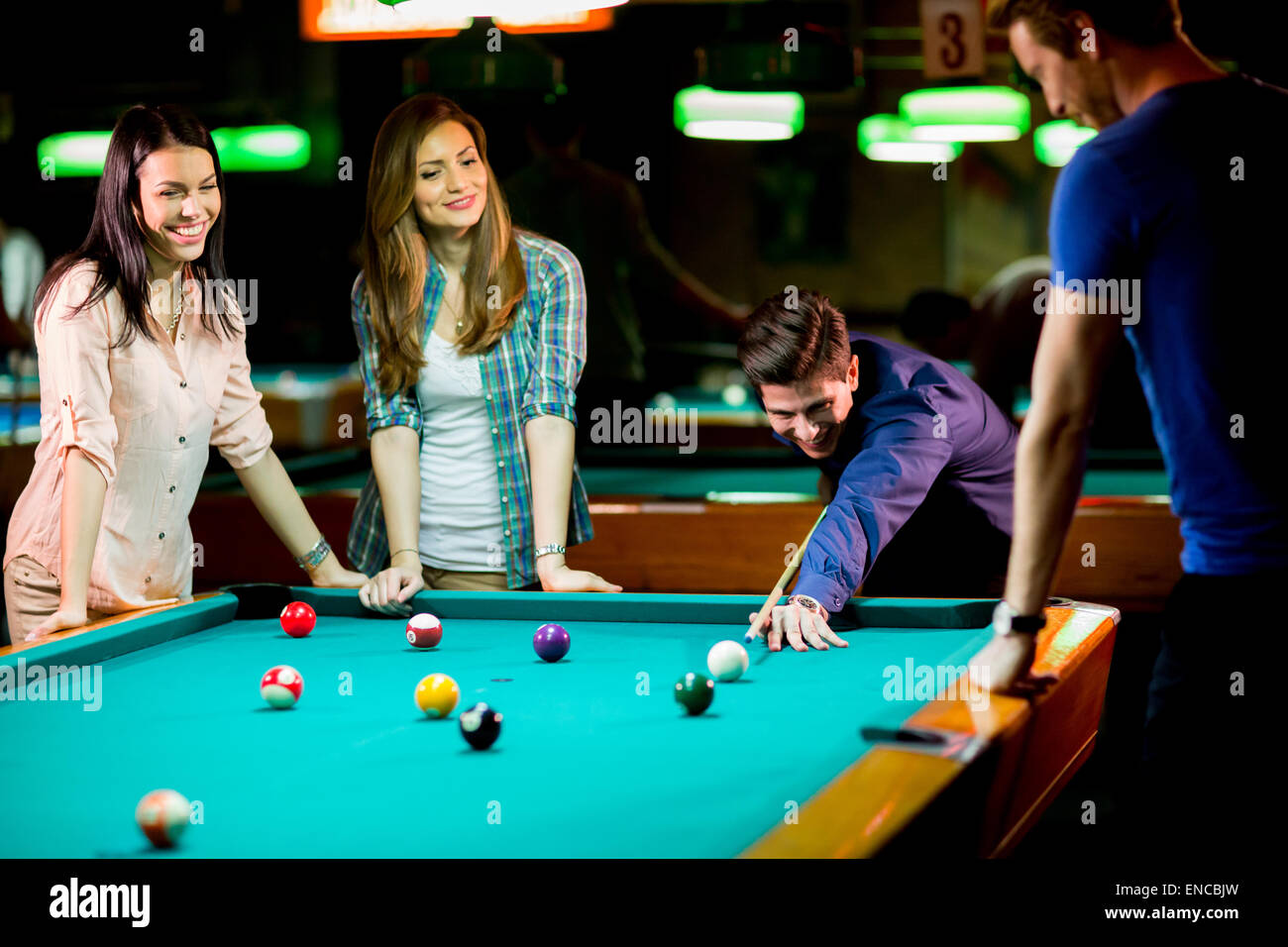Young people playing pool Stock Photo - Alamy