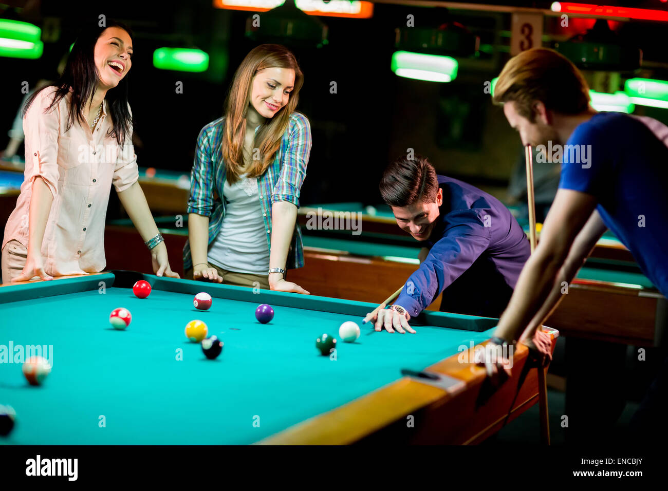 Young people playing pool Stock Photo - Alamy
