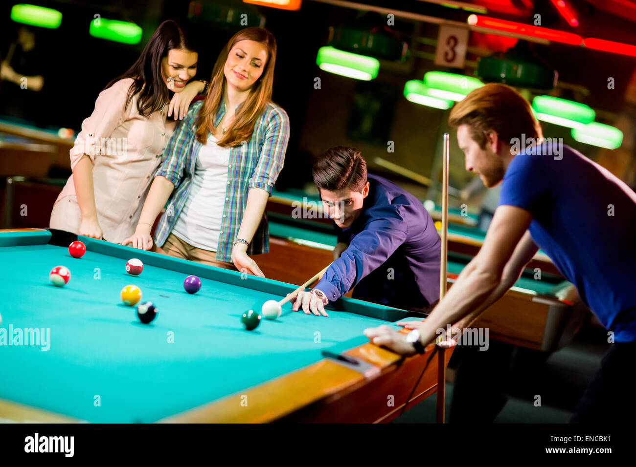 Young people playing pool Stock Photo - Alamy
