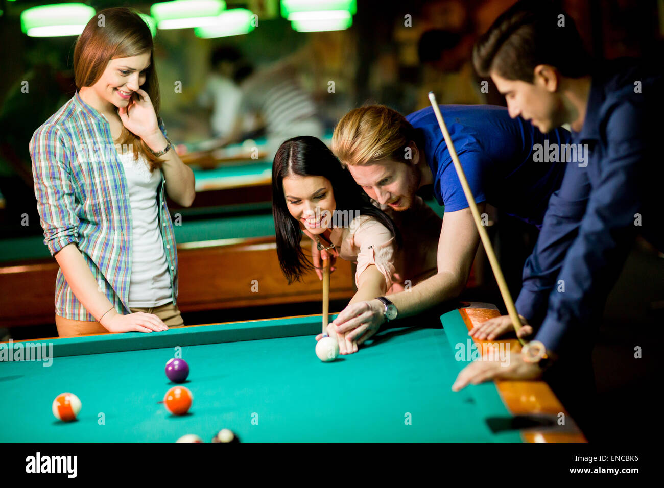 Young people playing pool Stock Photo - Alamy