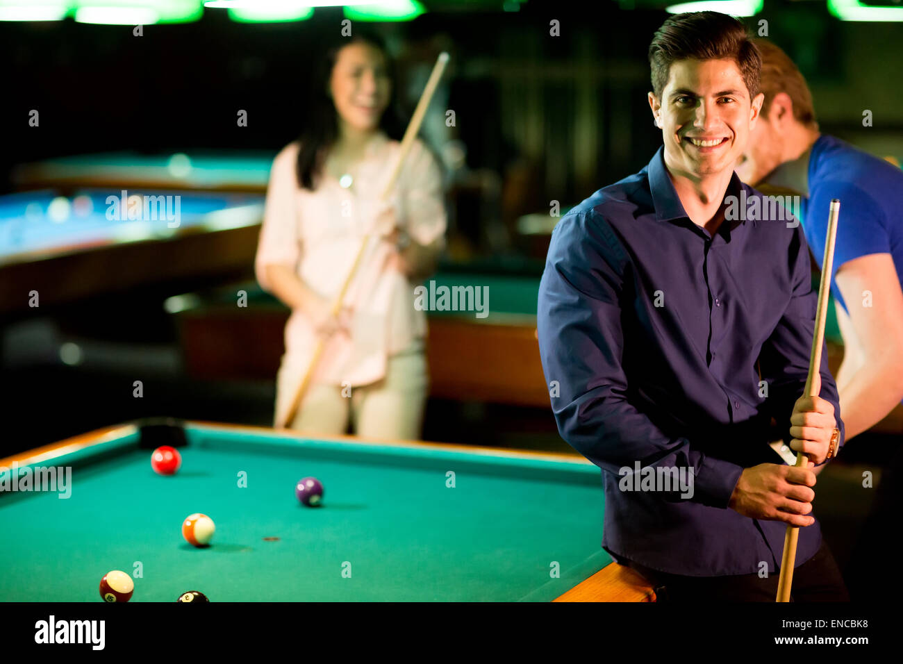 Young people playing pool Stock Photo - Alamy