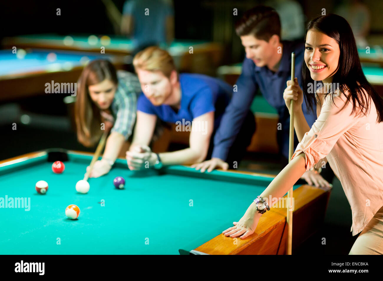 Young people playing pool Stock Photo - Alamy