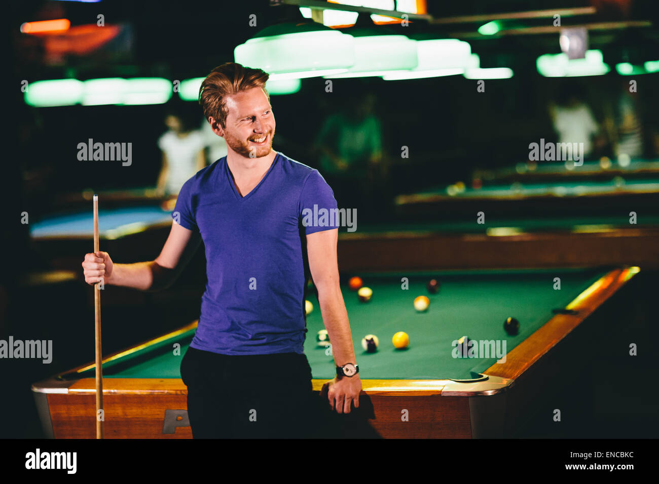 Young man playing pool Stock Photo - Alamy