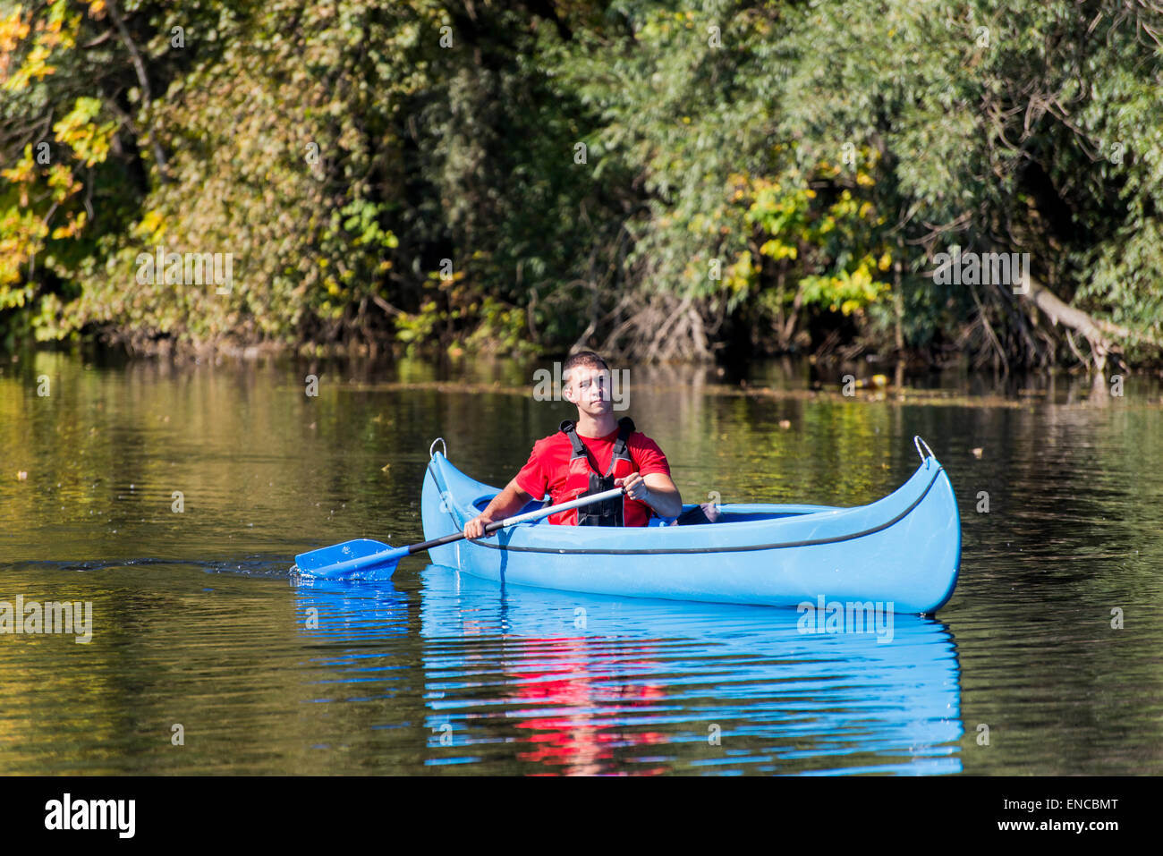 Young man in canoe Stock Photo - Alamy