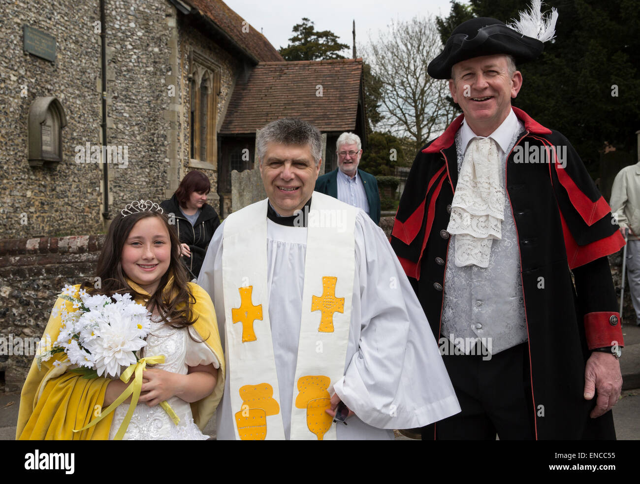 The May Queen Tia George stands with the parish vicar in Downe village ...