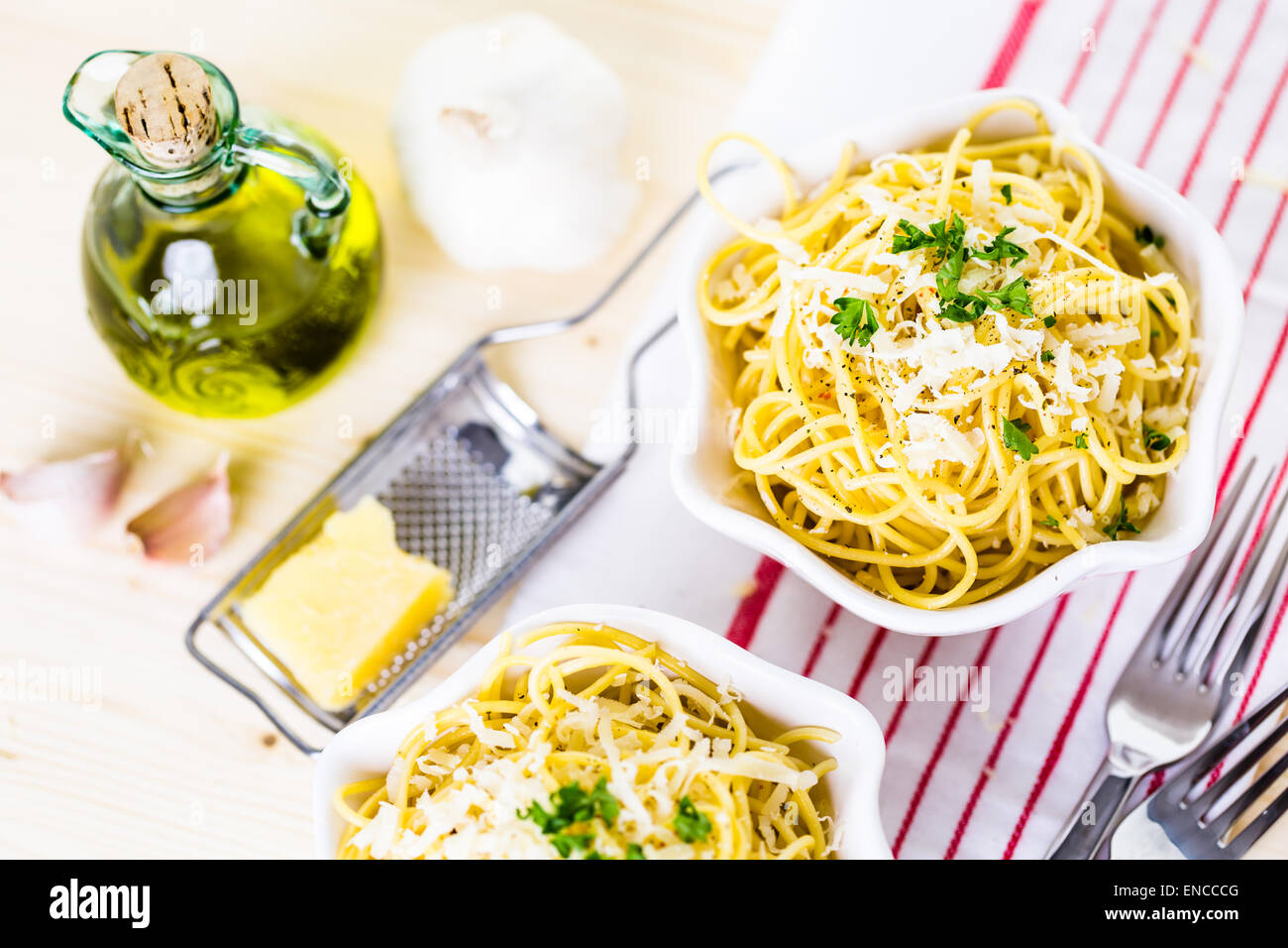 Cheese and pepper spaghetty with green garnish in white bowls Stock ...