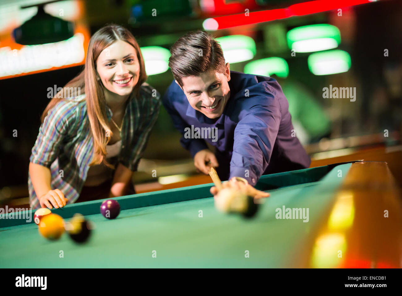 Young couple playing pool Stock Photo - Alamy