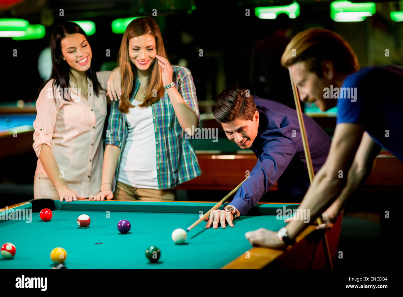 Young people playing pool Stock Photo - Alamy