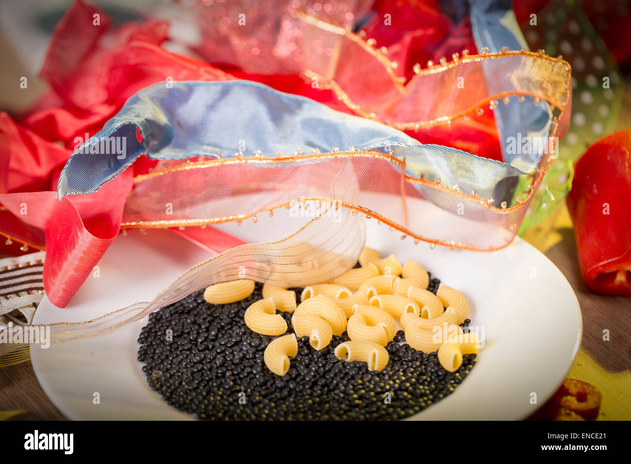raw pasta and black beluga lentils and a pile of gift ribbons Stock ...