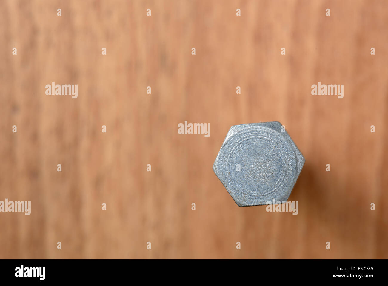 One bolt on wood blur background Stock Photo - Alamy
