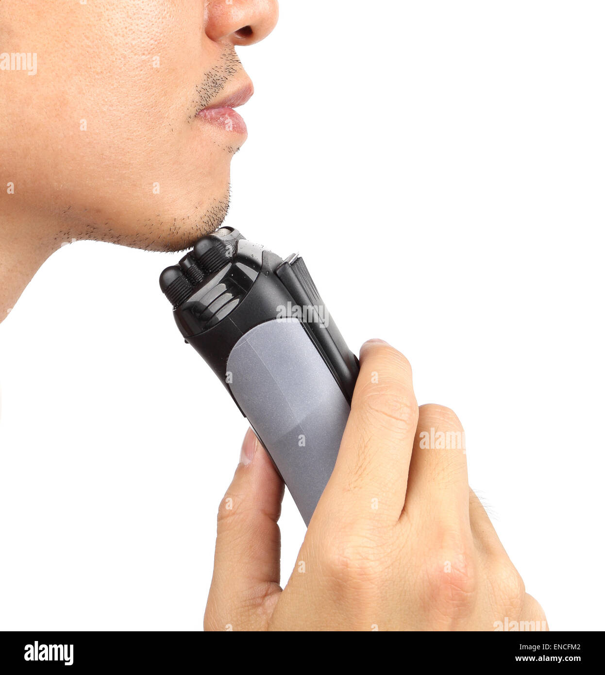 Young man shaving his beard off with an electric shaver Stock Photo - Alamy