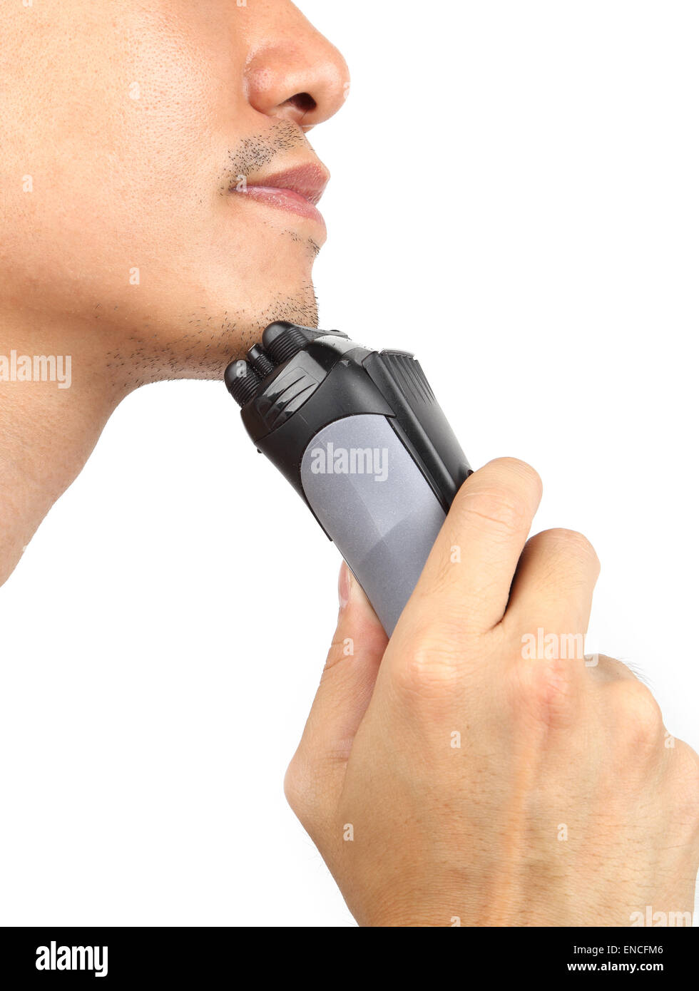 Young man shaving his beard off with an electric shaver Stock Photo - Alamy