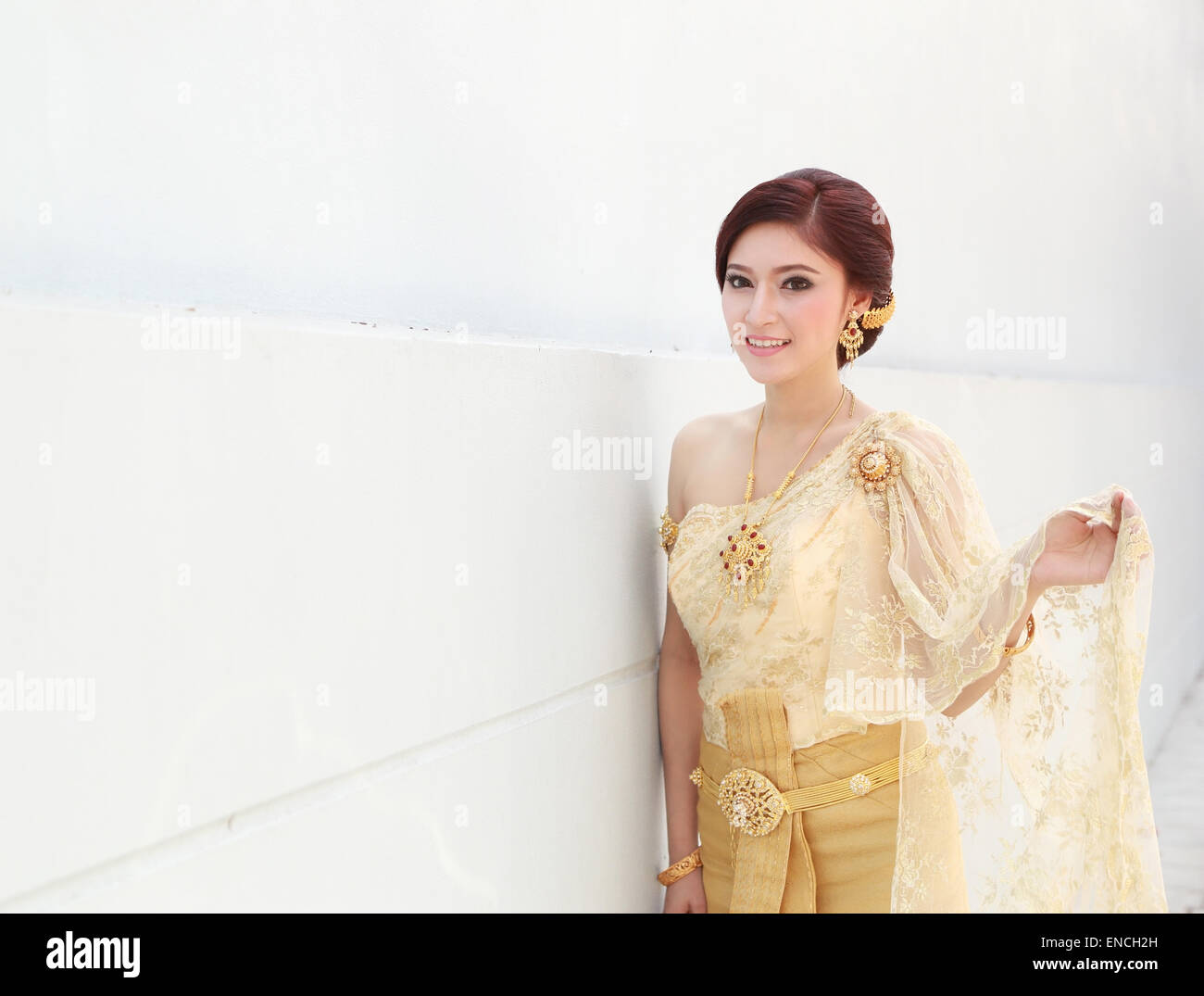 woman with Thai dress and wall background Stock Photo - Alamy