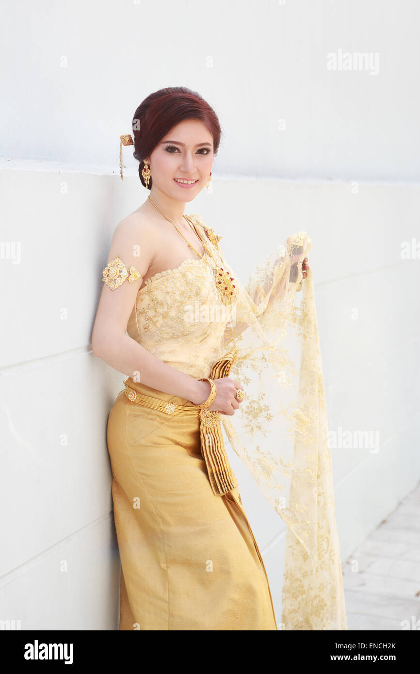 woman with Thai dress and wall background Stock Photo - Alamy