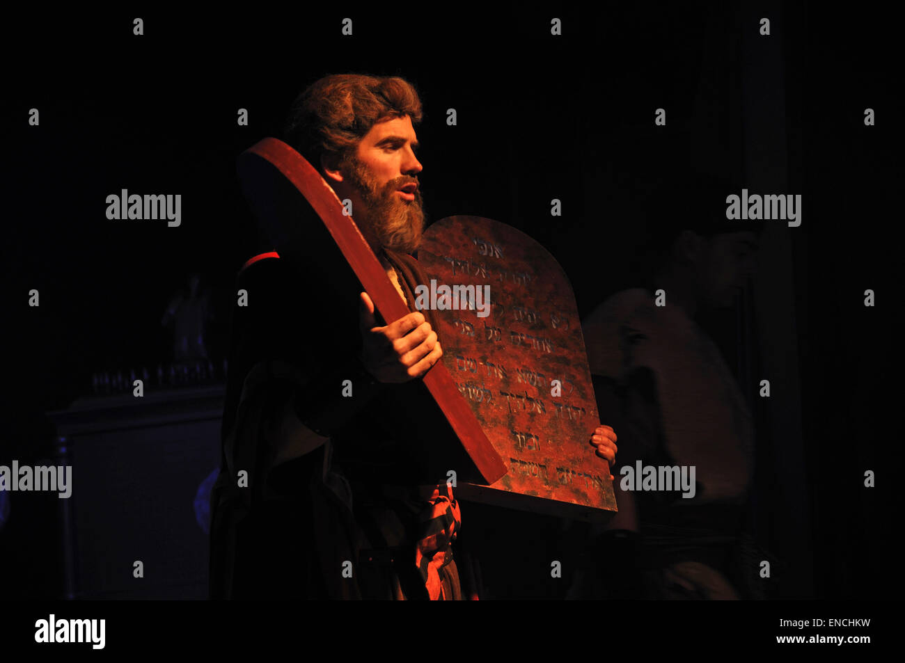 Actor dressed as Moses holding stage props of the Biblical Ten ...