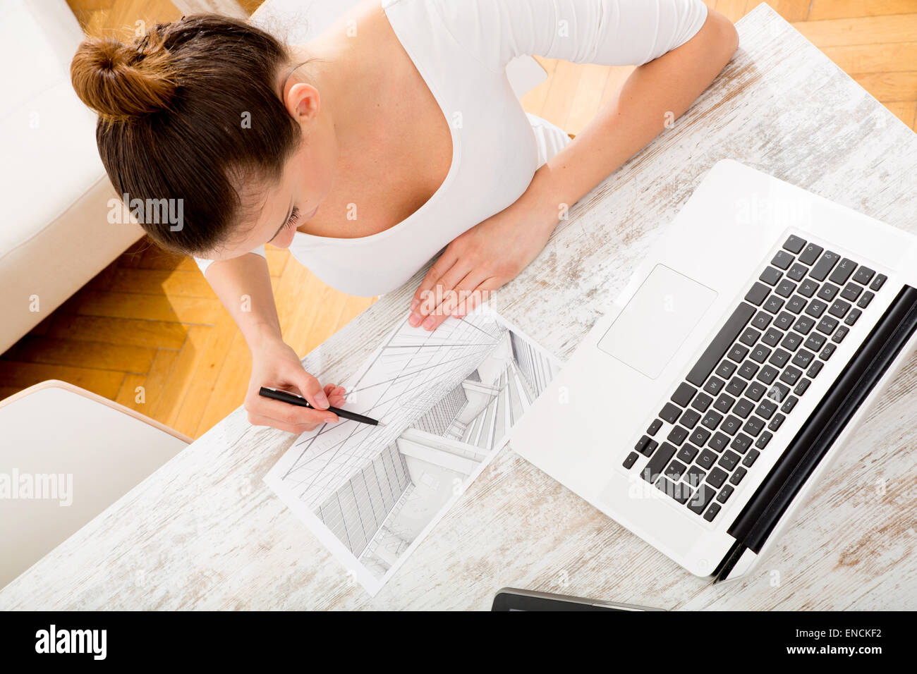 A young adult woman developing a architectural plan at home Stock Photo ...