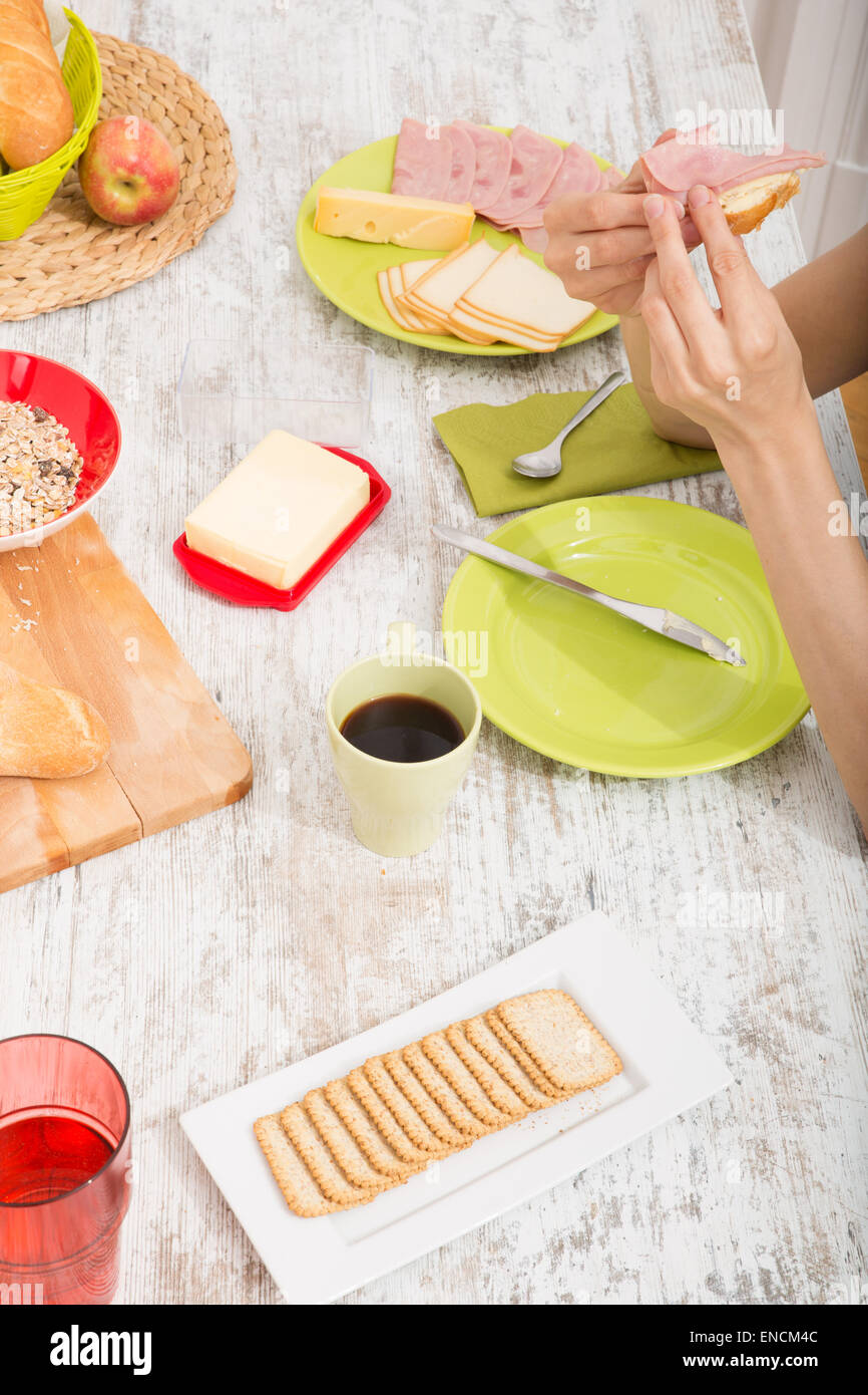 A young adult woman eating an european style ham sandwich Stock Photo ...
