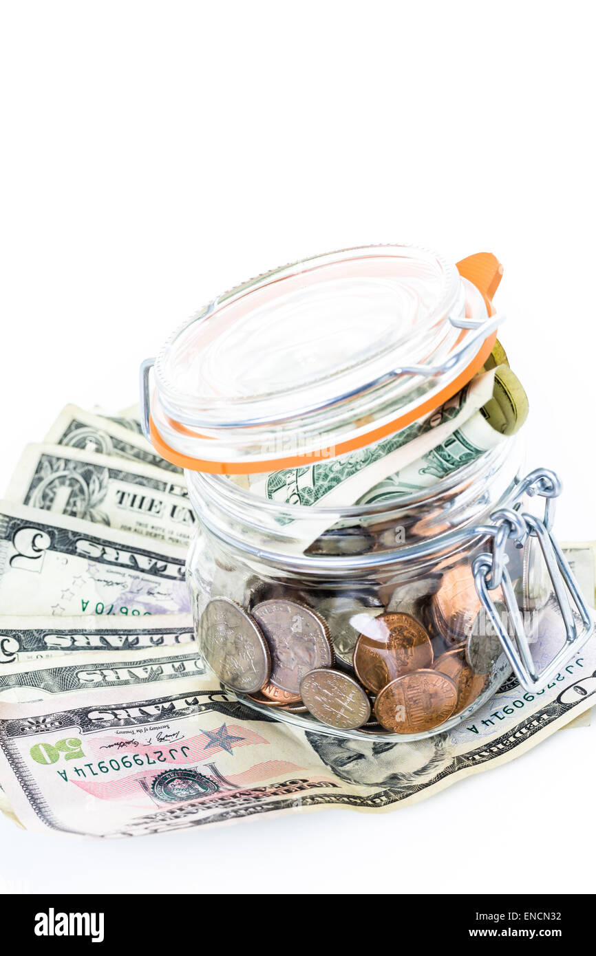Saving money into glass jar for future investment Stock Photo - Alamy