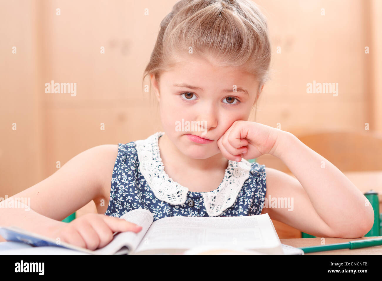 Sad little reading girl Stock Photo - Alamy