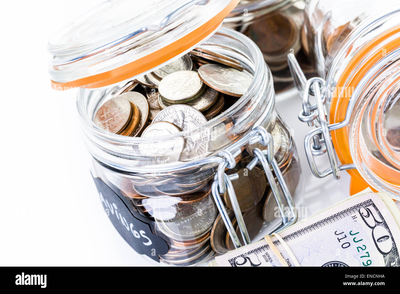 Saving money into glass jar for future investment Stock Photo - Alamy