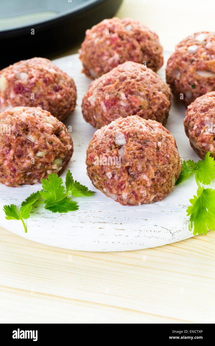 Cooking large homemade Italian meatballs for dinner Stock Photo - Alamy