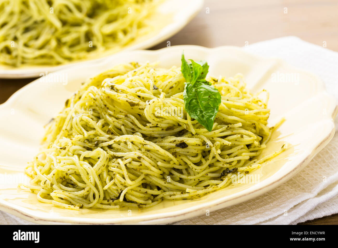 Homemade angel hair pasta with pesto sauce and roasted cherry tomatoes ...