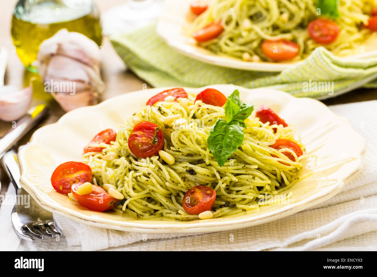 Homemade angel hair pasta with pesto sauce and roasted cherry tomatoes ...