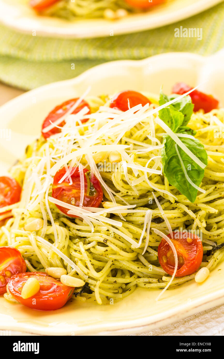 Homemade angel hair pasta with pesto sauce and roasted cherry tomatoes ...