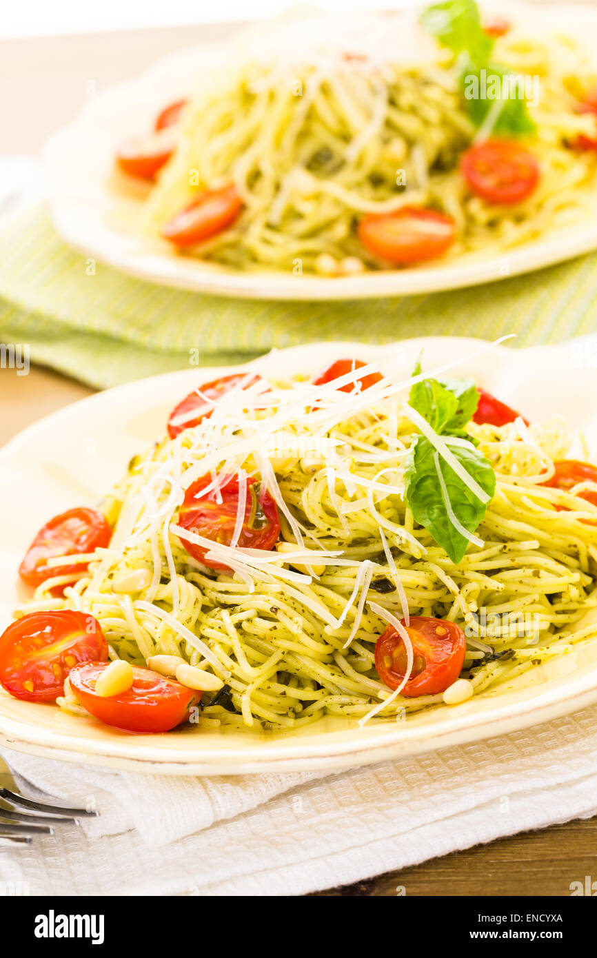 Homemade angel hair pasta with pesto sauce and roasted cherry tomatoes ...
