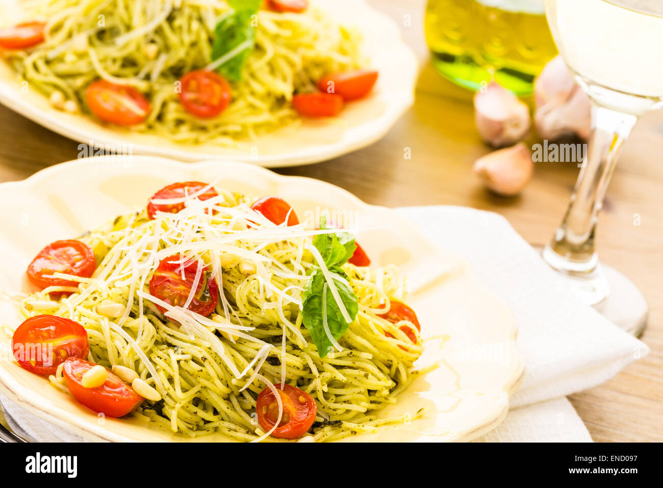 Homemade angel hair pasta with pesto sauce and roasted cherry tomatoes ...