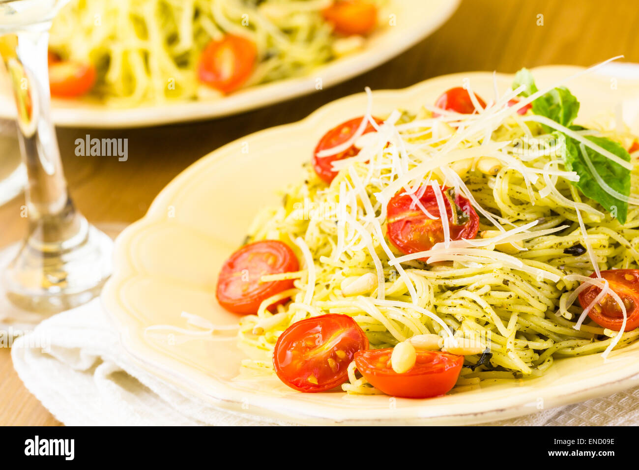 Homemade angel hair pasta with pesto sauce and roasted cherry tomatoes ...
