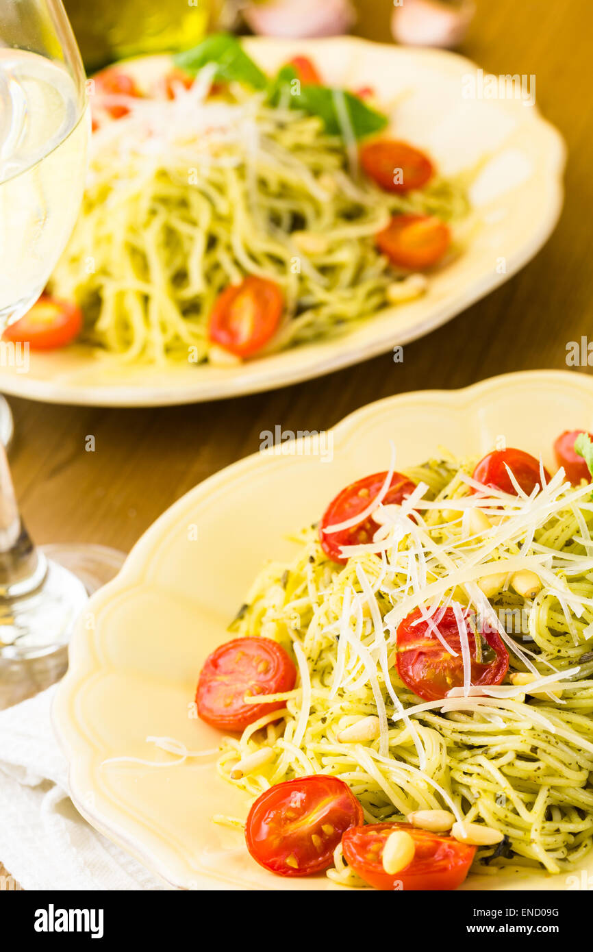 Homemade angel hair pasta with pesto sauce and roasted cherry tomatoes ...