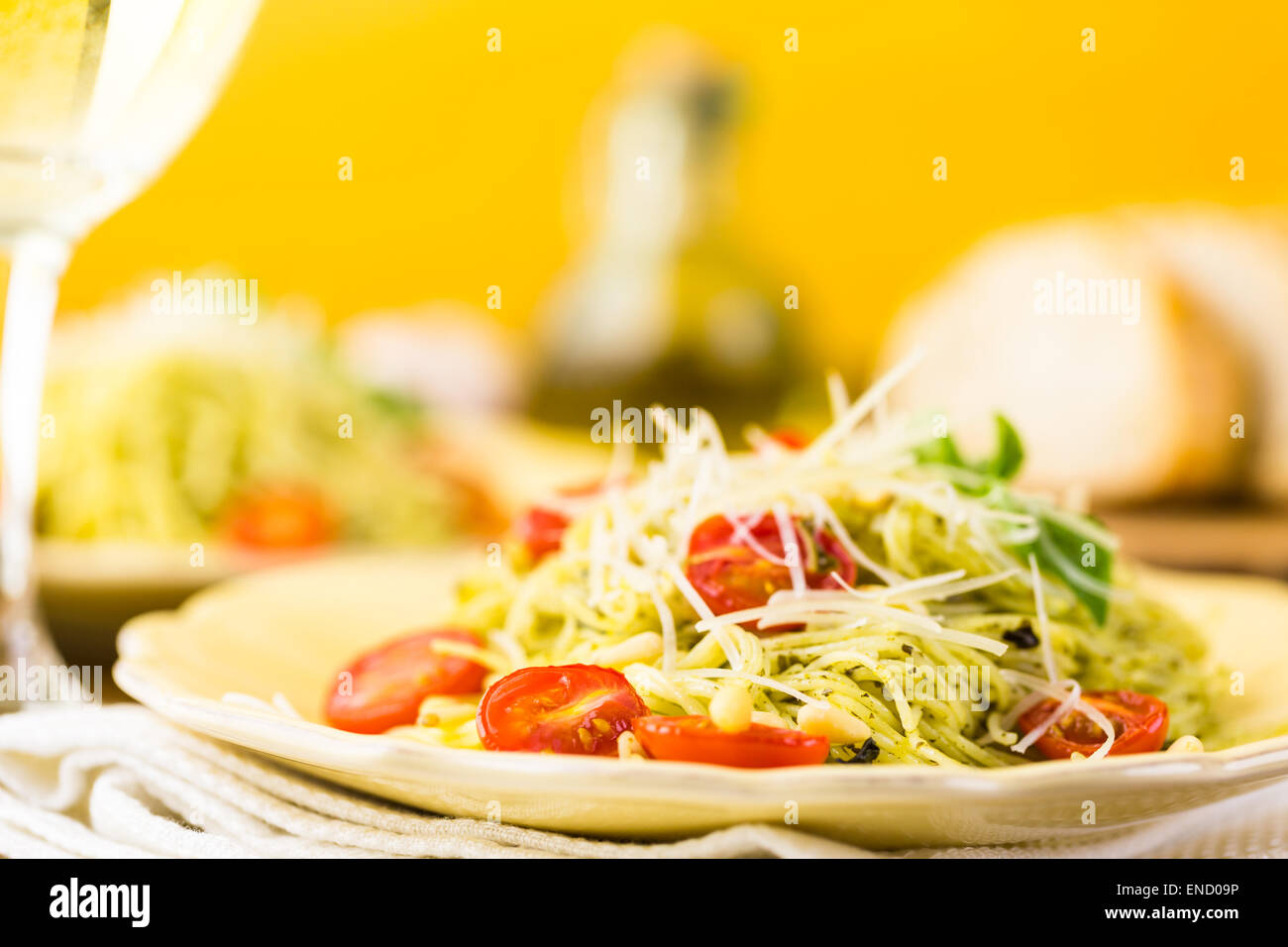 Homemade angel hair pasta with pesto sauce and roasted cherry tomatoes ...
