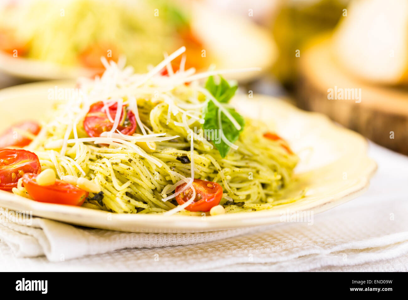 Homemade angel hair pasta with pesto sauce and roasted cherry tomatoes ...