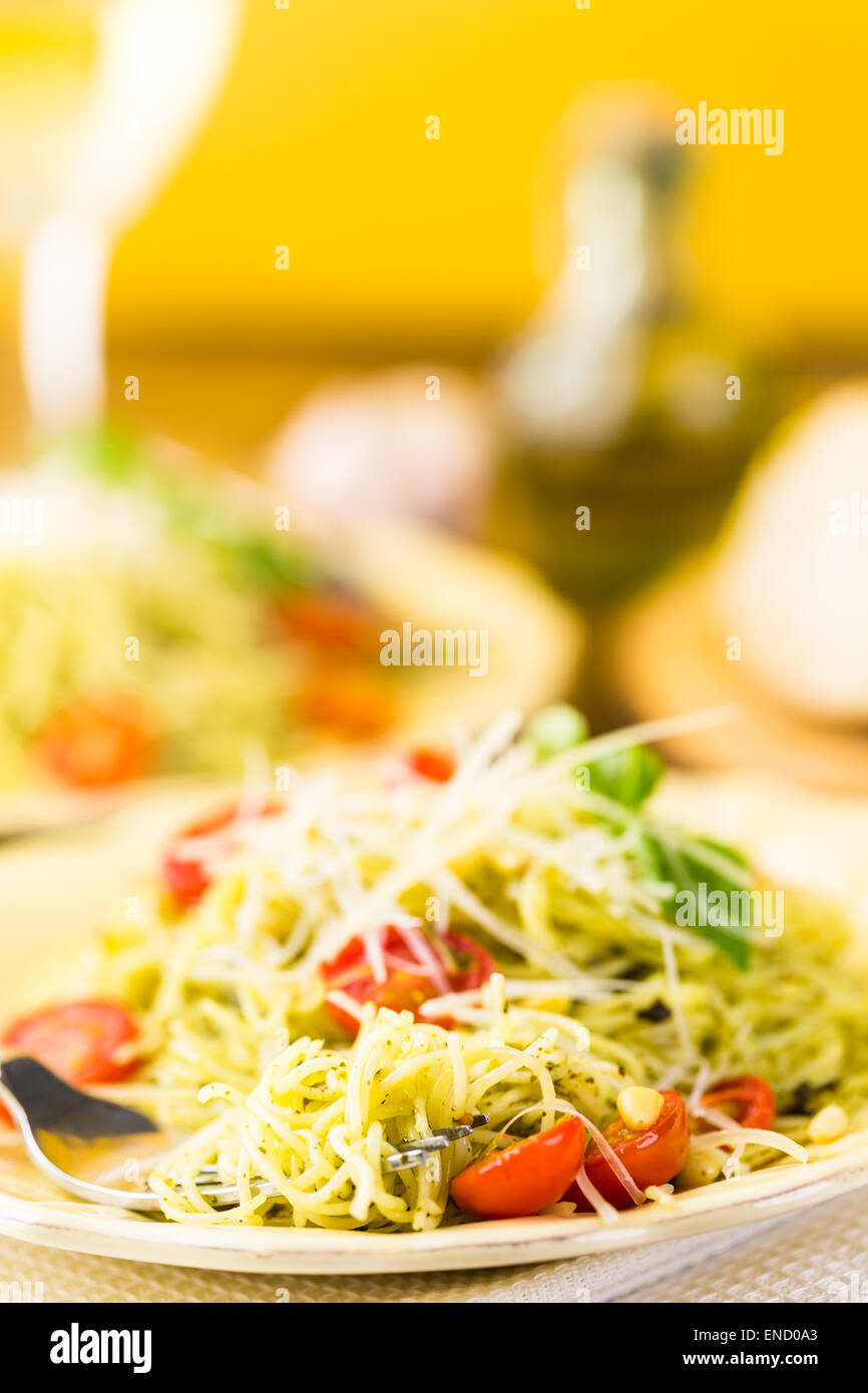 Homemade angel hair pasta with pesto sauce and roasted cherry tomatoes ...