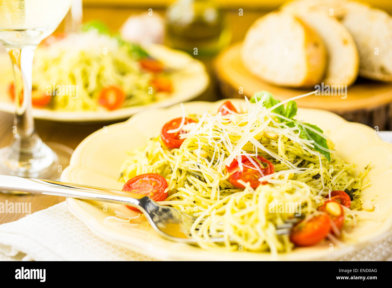 Homemade angel hair pasta with pesto sauce and roasted cherry tomatoes ...