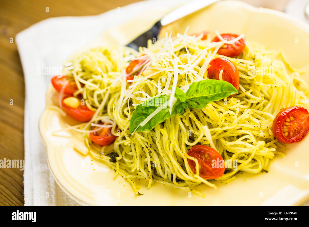Homemade angel hair pasta with pesto sauce and roasted cherry tomatoes ...
