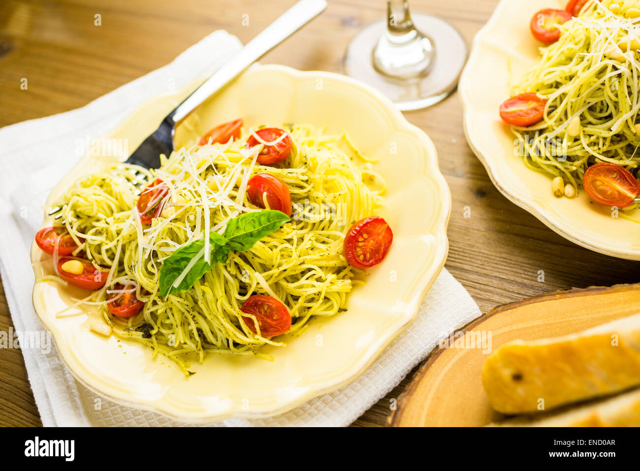 Homemade angel hair pasta with pesto sauce and roasted cherry tomatoes ...